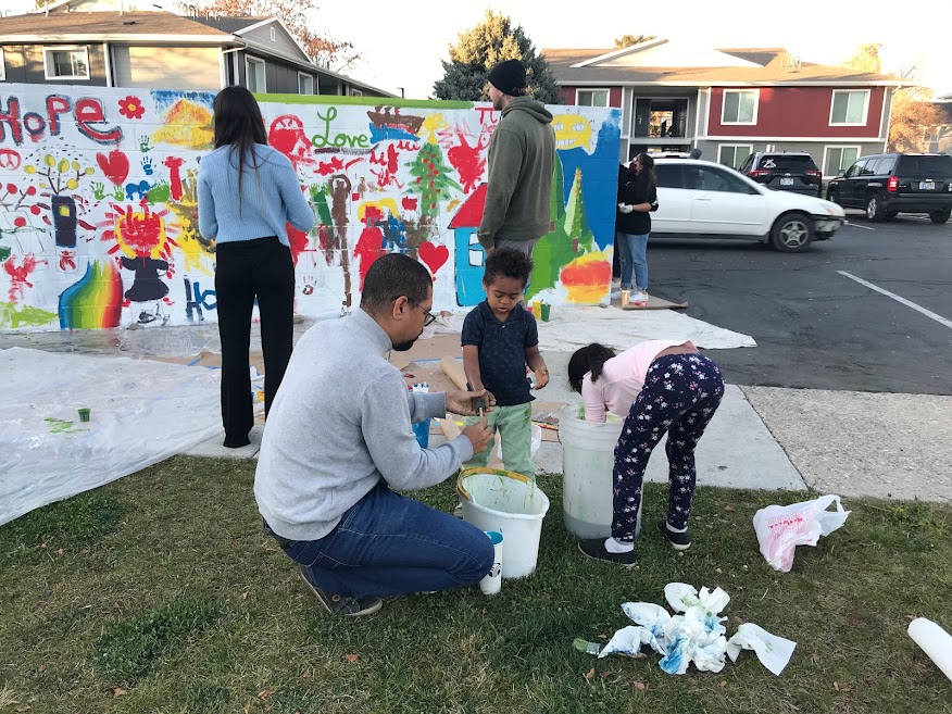 Artists brighten up neighborhood through colorful mural, with kids ...